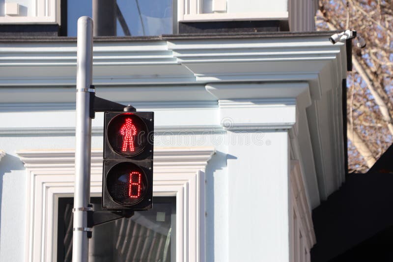 The Red Pedestrian Signal Features a Countdown Timer Positioned at the ...