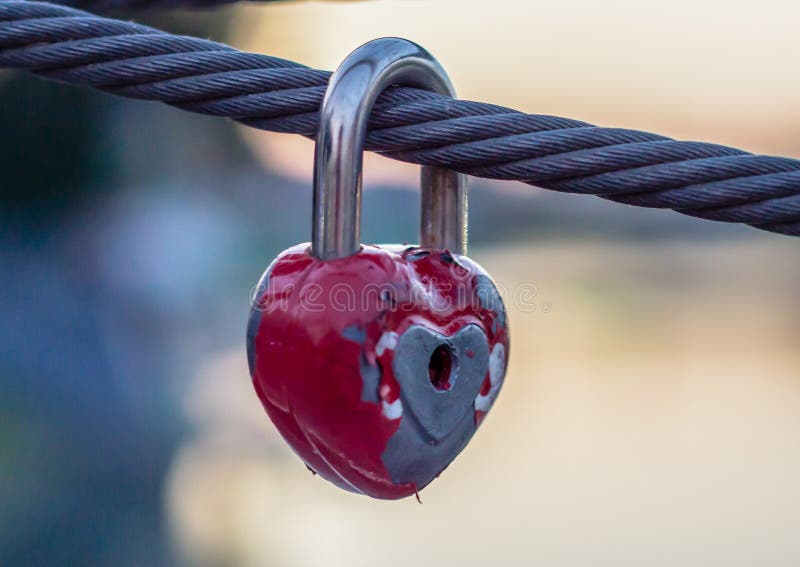 Red Peeling Wedding Lock on a Rope with a Key Hole Stock Photo - Image ...