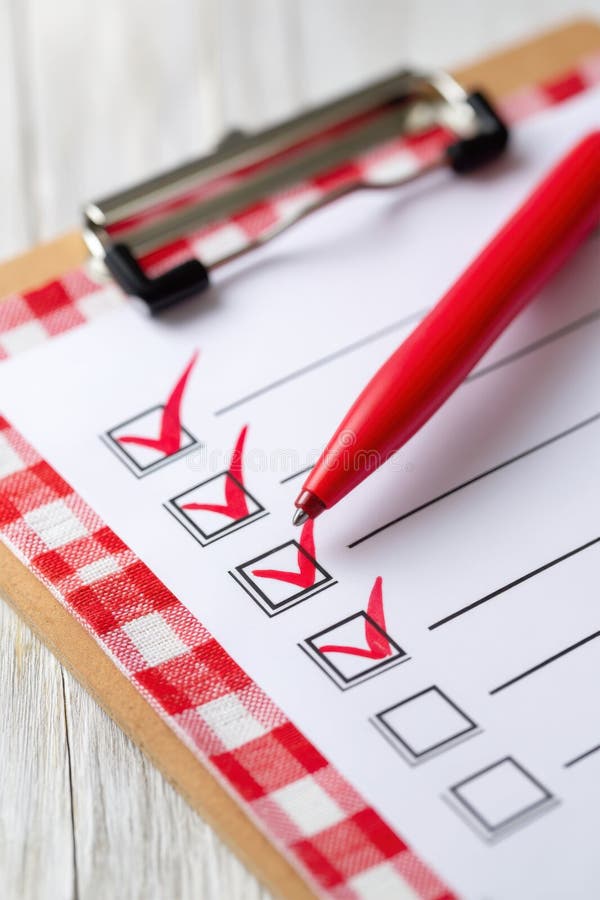 Red Pen Checking Boxes on Checklist on Clipboard with Red Gingham ...