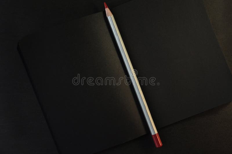 Red Pencil for Drawing on the Black Notepad Stock Image - Image of ...