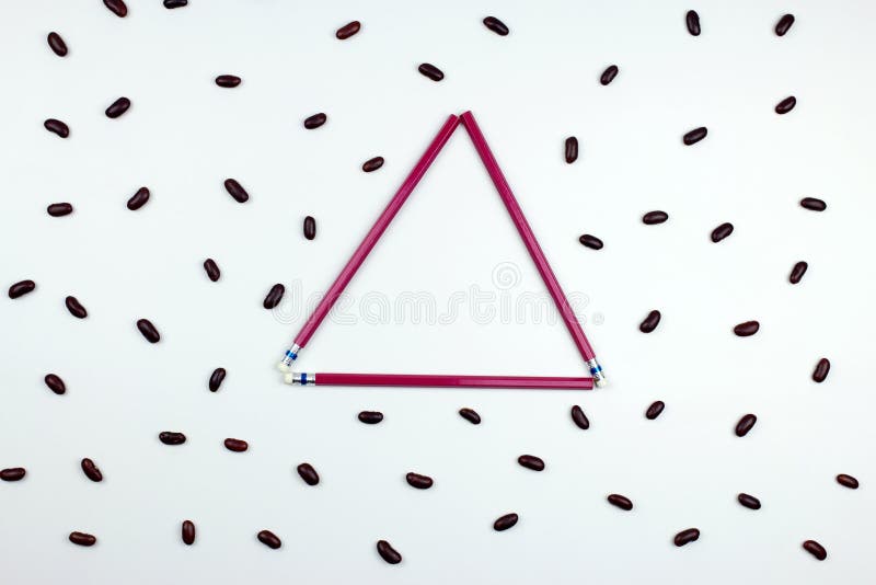 Red Pencils Triangle Frame with Red Beans on White Background. Stock ...