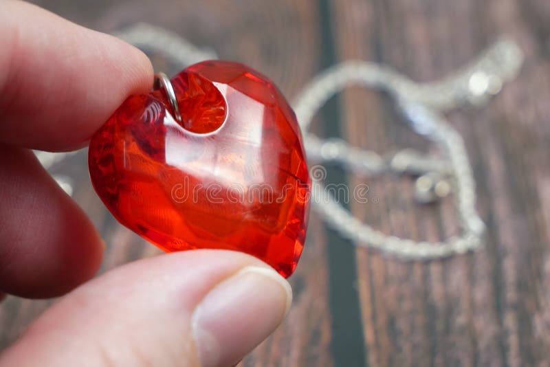 Red Pendant As Heart with Chain on Hand Stock Photo - Image of jewel ...