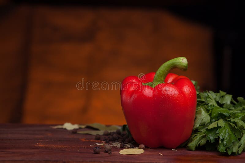 Red Pepper on Dark Wood Background with Herbs Stock Photo - Image of ...