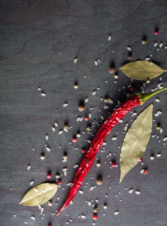 Red Pepper Pungent Spices and Bay Leaf on the Black Tree. View from ...
