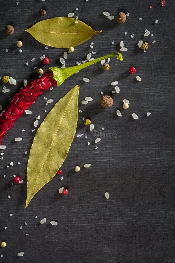 Red Pepper Pungent Spices and Bay Leaf on the Black Tree. View from ...