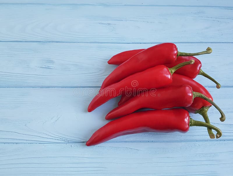 Red pepper on blue wooden stock image. Image of border - 110153361