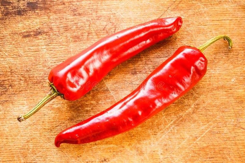 Red Peppers on Old Wooden Table Stock Photo - Image of closeup, garnish ...