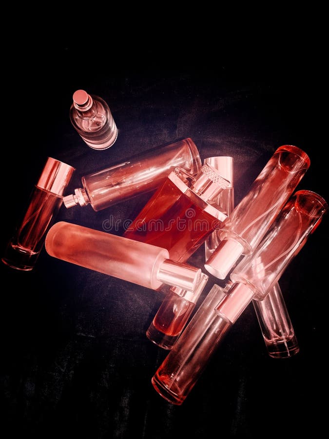 A Red Perfume Bottle among Various Clear Bottles. Stock Photo - Image ...