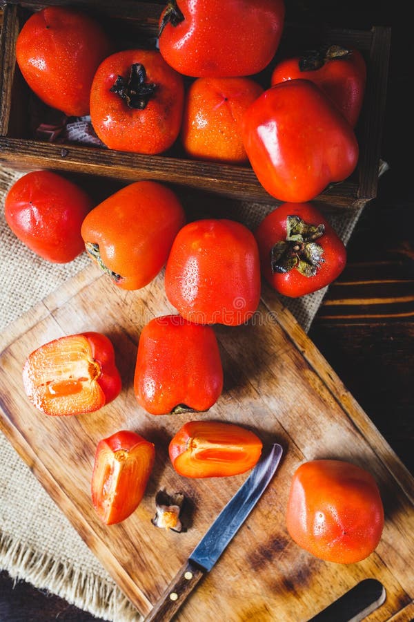Red Persimmons stock photo. Image of cuttingboard, burlap - 83274784