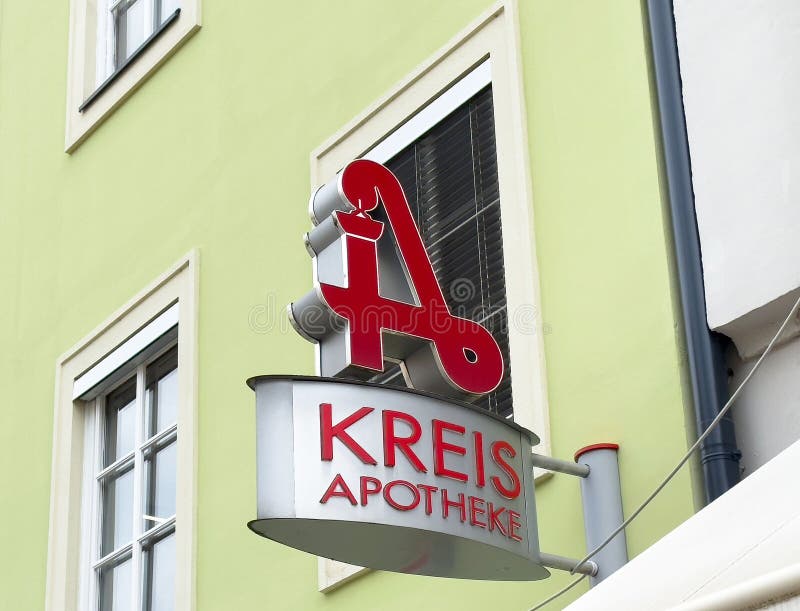 Red Pharmacy Sign on Green Building Wall in Urban Setting Editorial ...