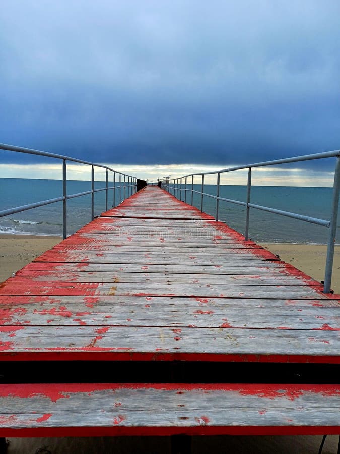Red pier on the beach stock photo. Image of transport - 306375446