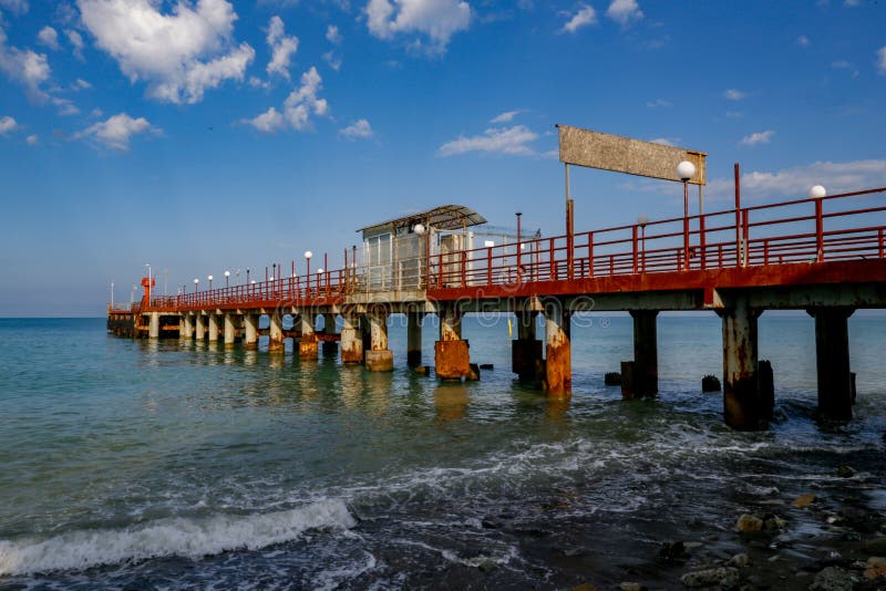 Red Pier Near the Beach with Small Stones Stock Photo - Image of beauty ...