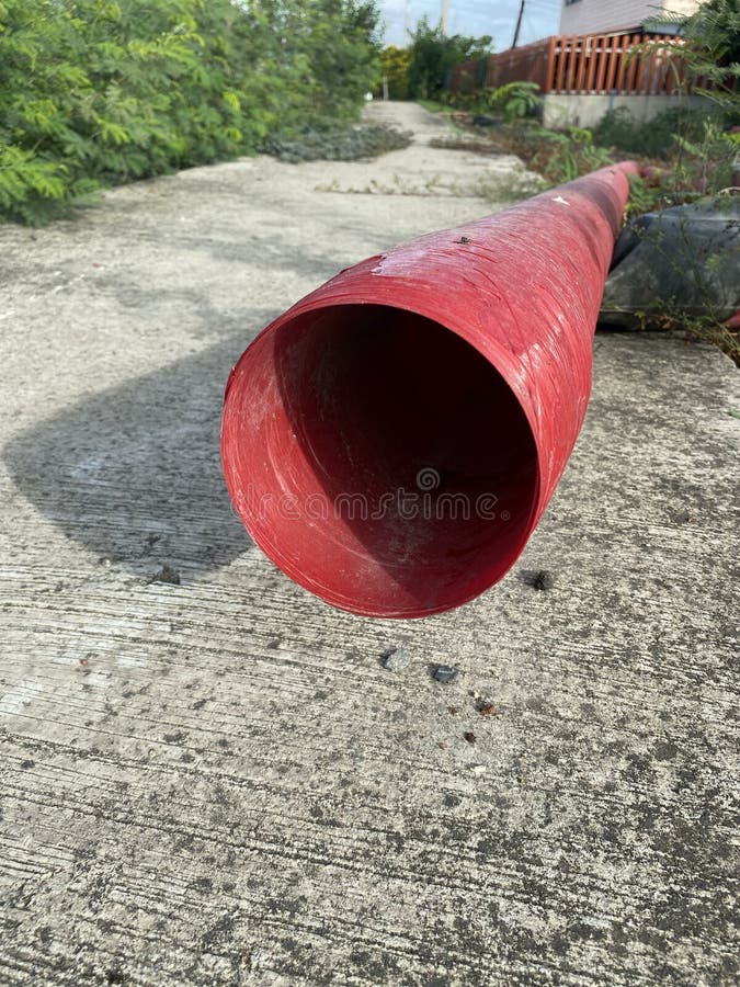 Red pipe on the ground stock photo. Image of rough, closeup - 206307336