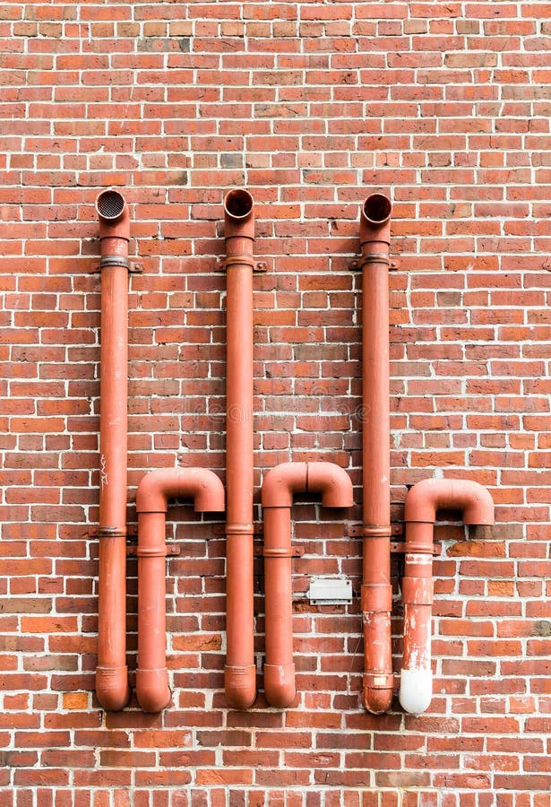 Red Pipes on Red Brick Wall Stock Photo - Image of door, facade: 50454626