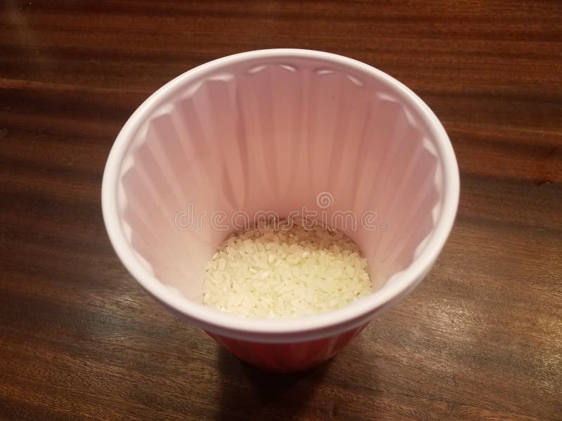 Red Plastic Cup of Rice on Brown Wood Table Stock Photo - Image of ...