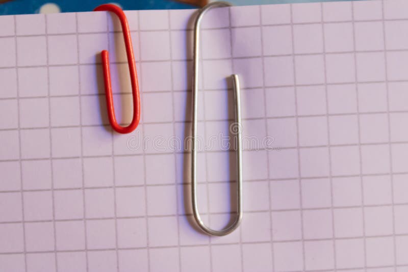 Red Plastic and Metal Paper Clips on Notebook Page - Image Stock Image ...