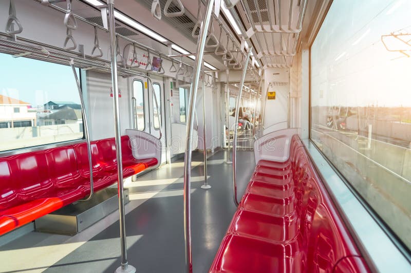 Red Plastic Seats and Chrome Handrails Inside an Electric Train ...