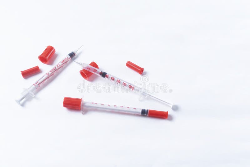 Red Plastic Syringes on a White Background with Copy Space. Top View ...