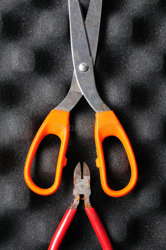 Red Pliers and Orange Scissors on Sponge Stock Photo - Image of rubber ...