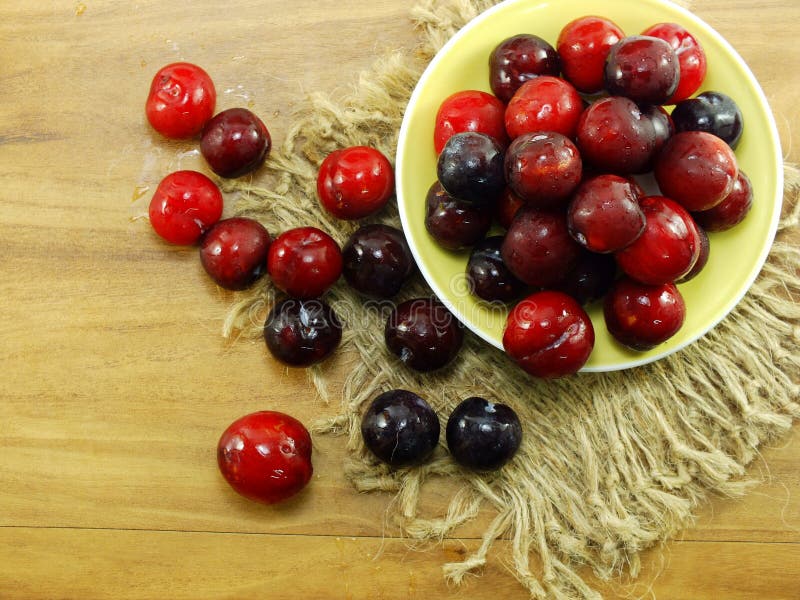 Red Plum on Wooden Background Top View Stock Image - Image of closeup ...
