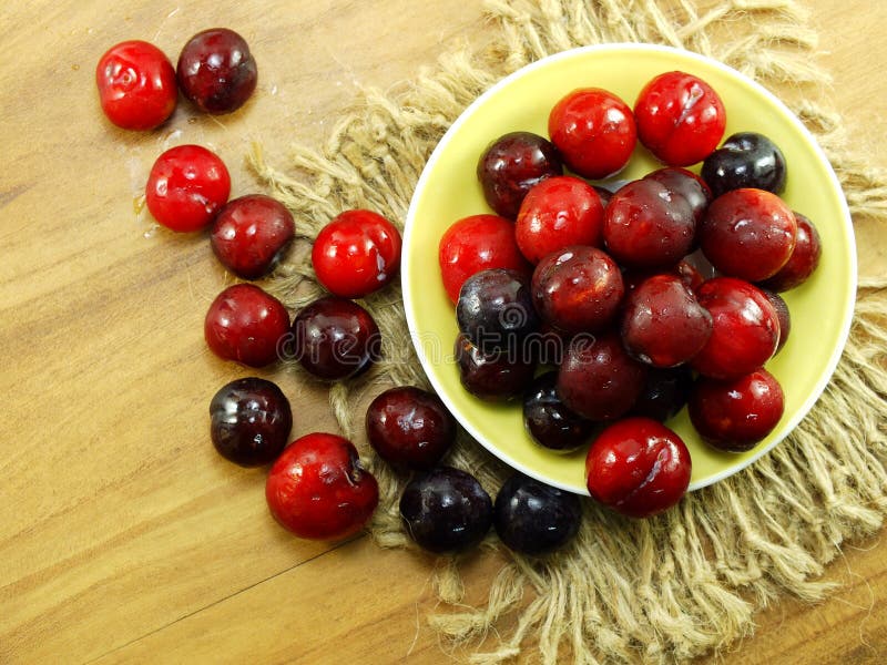 Red Plum on Wooden Background Top View Stock Image - Image of board ...
