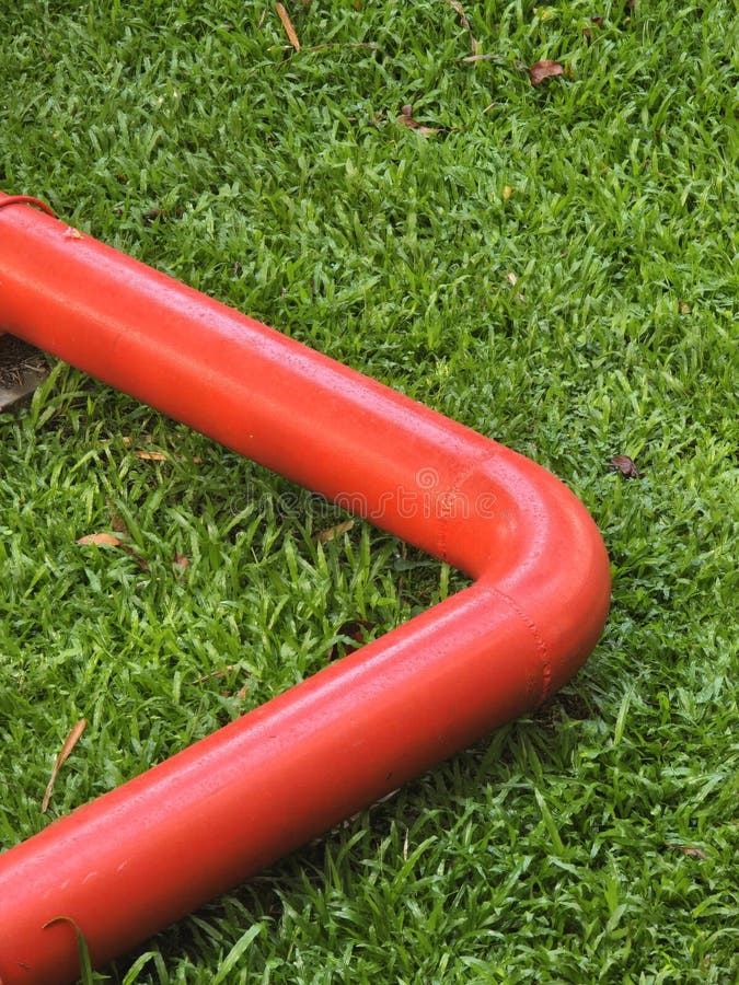 Red Plumbing Pipe at the Garden with Green Grass Stock Image - Image of ...