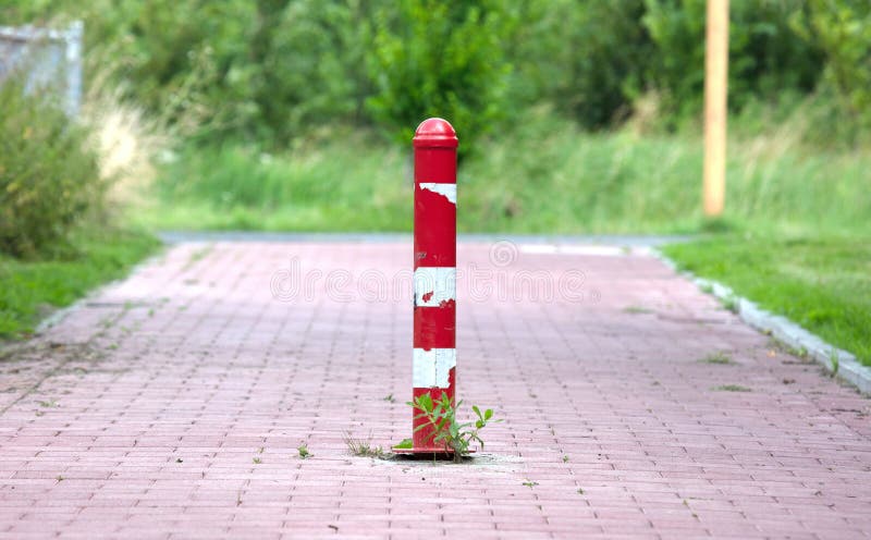 Red Pole in the Middle of a Bicycle Path Stock Photo - Image of stone ...