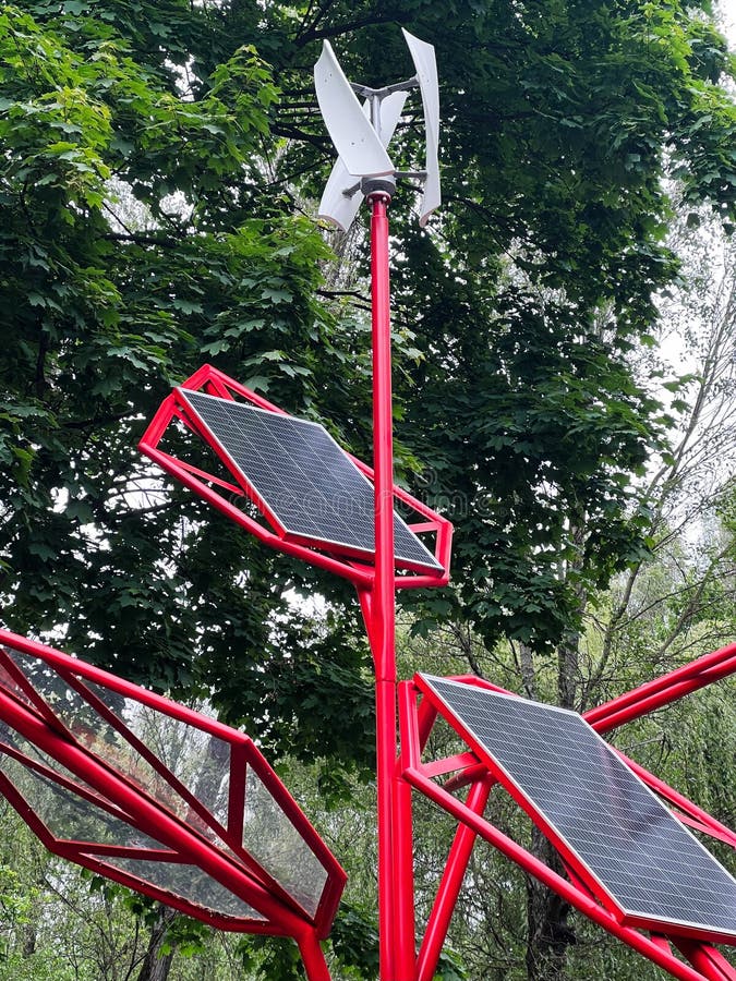 Red Pole with Solar Panels and Wind Turbine in a Green Forest ...