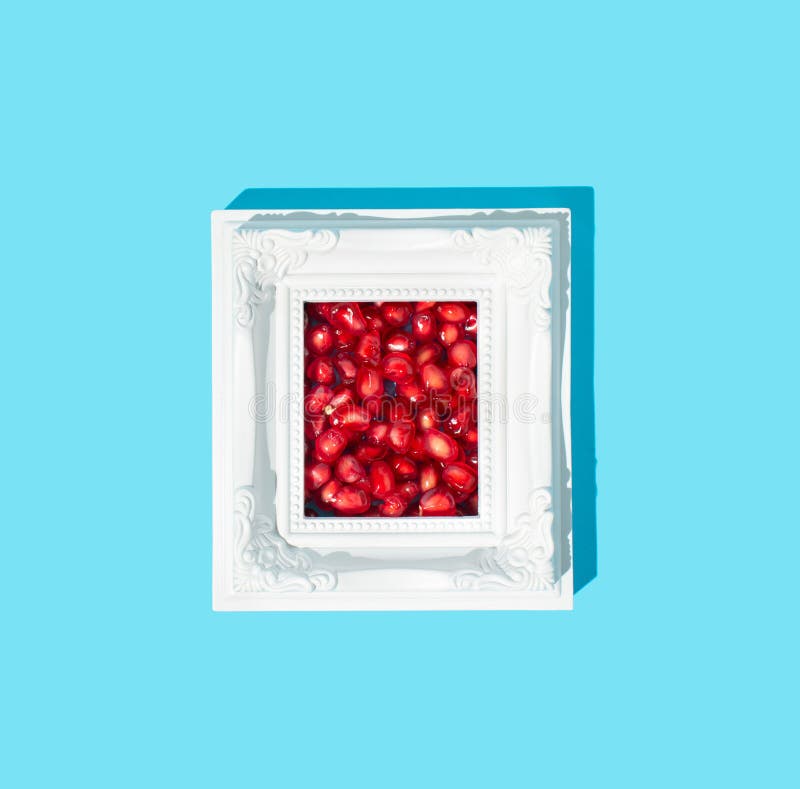 Red Pomegranate Seeds on White Frame Isolated on Blue Background ...