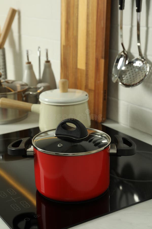 Red Pot on Electric Stove in Kitchen. Cooking Utensil Stock Photo ...