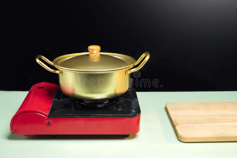 A Red Pot Sits on Top of a Burner on a Stove Stock Image - Image of ...
