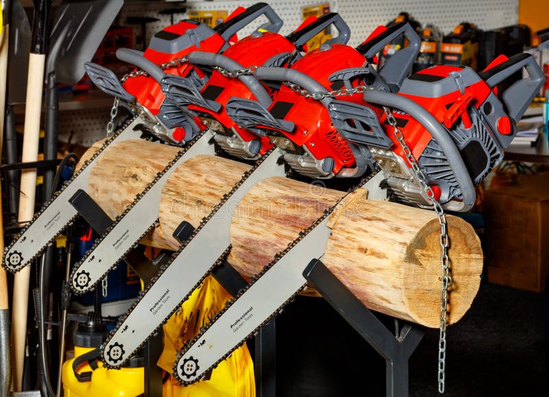 Red Chainsaws are Stuck in a Log. Professional Garden Tool Concept ...