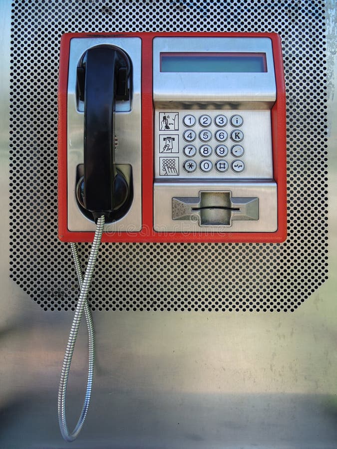 Red public phone on a wall stock photo. Image of instruction - 75845134
