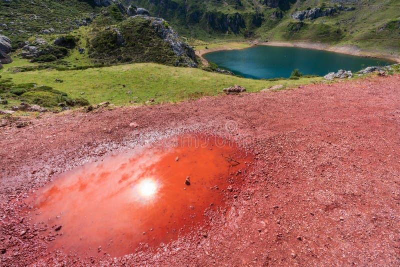Red Puddle with Sun Reflection and Lake Stock Photo - Image of contrast ...