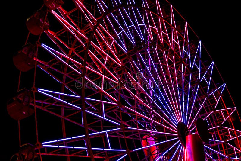 Red and Purple Light Fluorescent on Structure of Ferris Wheel with Dark ...