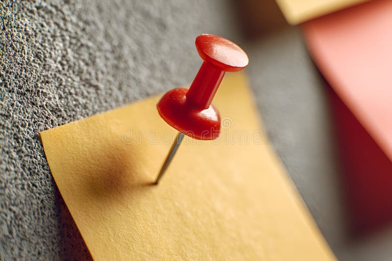 Red Push Pin Attaching Yellow Sticky Note To Gray Wall Stock Photo ...