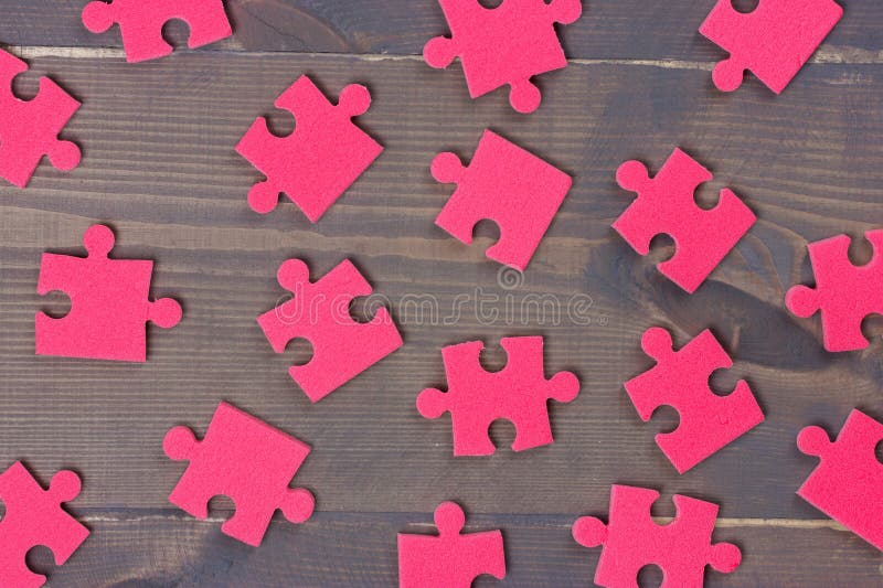 Red Puzzle Pieces Scattered on a Wooden Surface. Stock Image - Image of ...