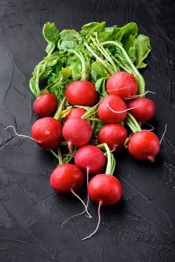 Red Radish Bunch with Green Leaves, on Black Stone Background Stock ...
