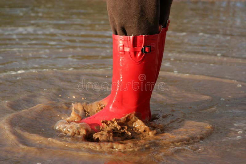 Red rain boots in puddle stock image. Image of standing - 3813007