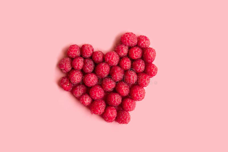 Red Raspberries in a Heart Shape on Pink Background Stock Photo - Image ...
