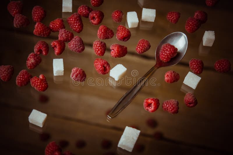 Berries of Red Raspberries with a Teaspoon and Cubes of Refined Sugar ...