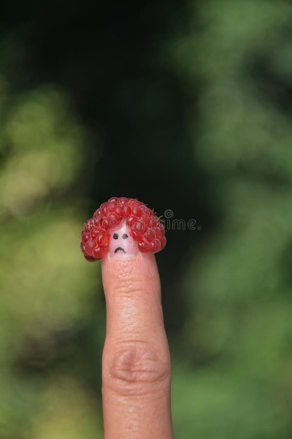 Red Raspberry on the Thumb with a Sad Face Stock Photo - Image of head ...