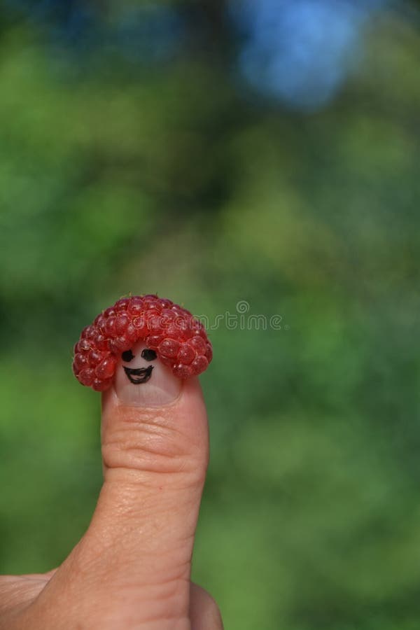 Red Raspberry on the Thumb with a Smiling Face Stock Image - Image of ...