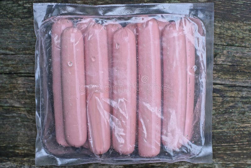 Red Raw Sausages in a White Transparent Plastic Cellophane Package ...