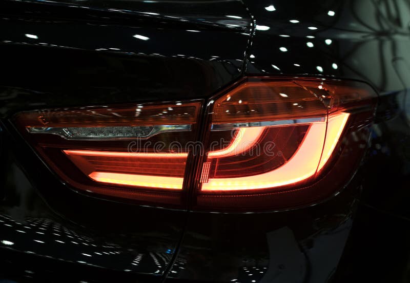 Red Rear Light on a Modern Black Car with Reflection. the Closeup Back ...