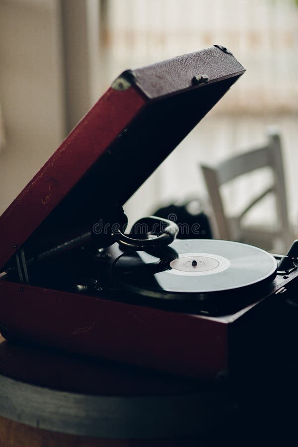 Red Record Player with a Black Needle Sits on a Wooden Table Stock ...