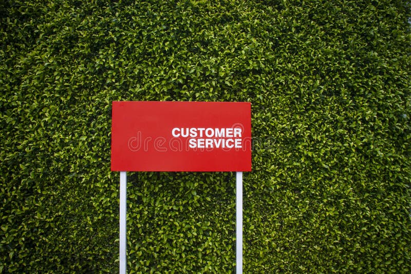 A Red Rectangular Customer Service Sign on White Poles with White ...