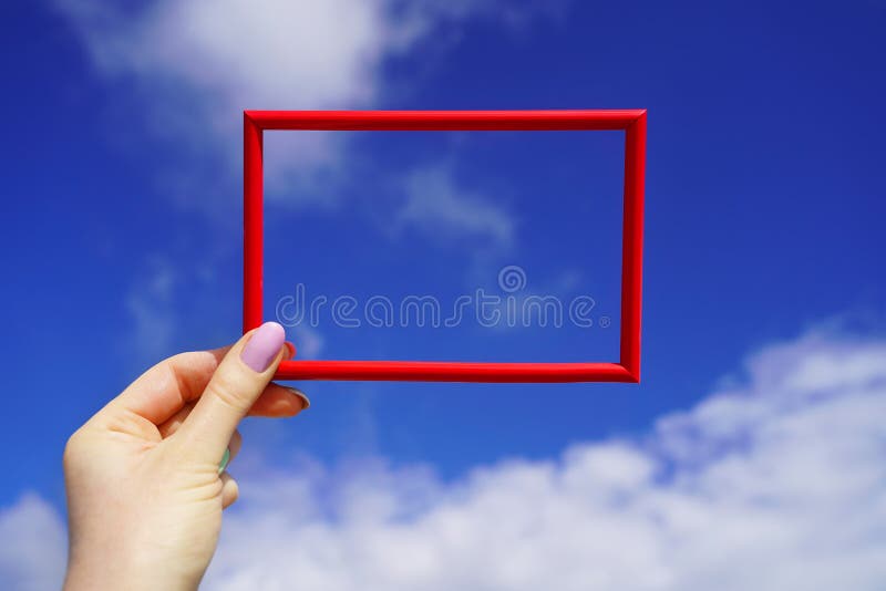 Red Rectangular Horizontal Frame in Female Hand Against Blue Sky ...