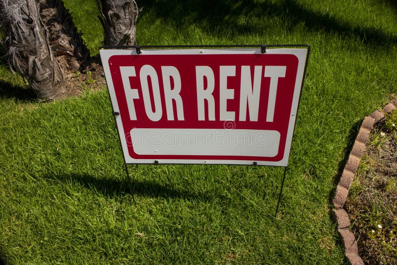 A Red for Rent Sign on a Lawn in Front of a House Stock Image - Image ...
