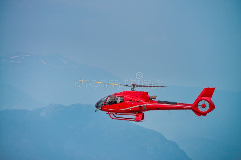Red Rescue Helicopter Flying in a Mountain Environment Stock Image ...